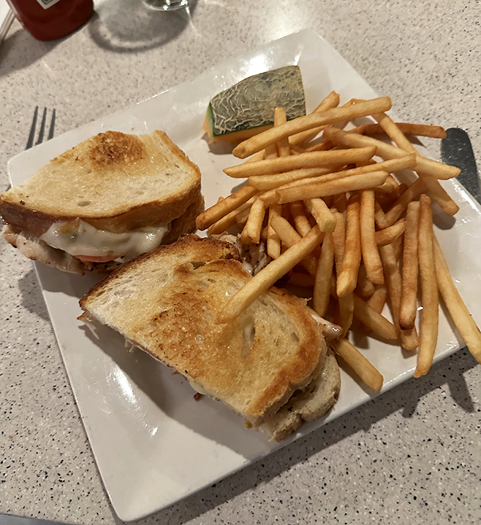 The sandwich that launched a thousand lunch breaks. Golden-toasted bread, melty cheese, and fries that demand to be stolen one by one.