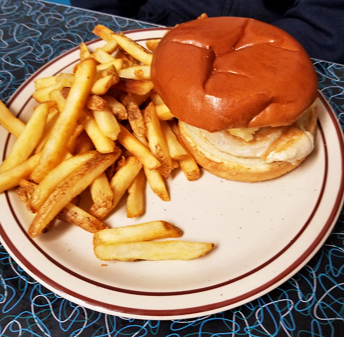 A sandwich and fries on a plate with that distinctive red stripe around the edge&mdash;the universal signal that good, honest food is about to happen.