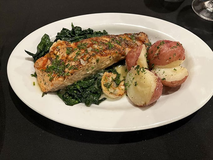 Grilled salmon that flakes at the mere suggestion of your fork, nestled on a bed of vibrant spinach.