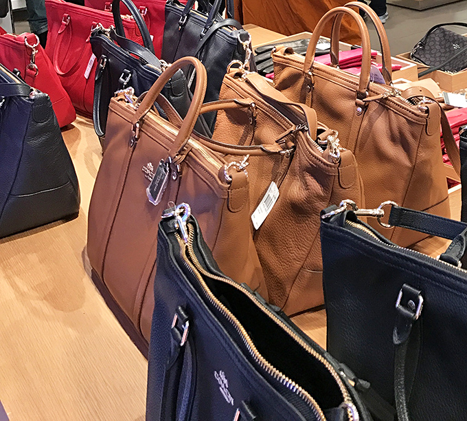 Designer handbags displayed like crown jewels prove that outlet prices don't mean compromising on looking absolutely fabulous every single day.