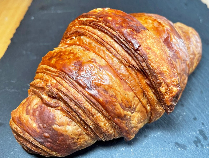This croissant has more layers than a prestige HBO drama, with a golden exterior that deserves its own award ceremony.