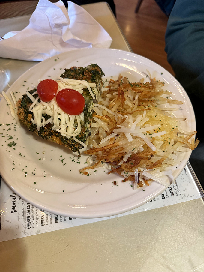 A quiche that doesn't skimp on the good stuff, paired with hashbrowns so crispy they deserve their own fan club.