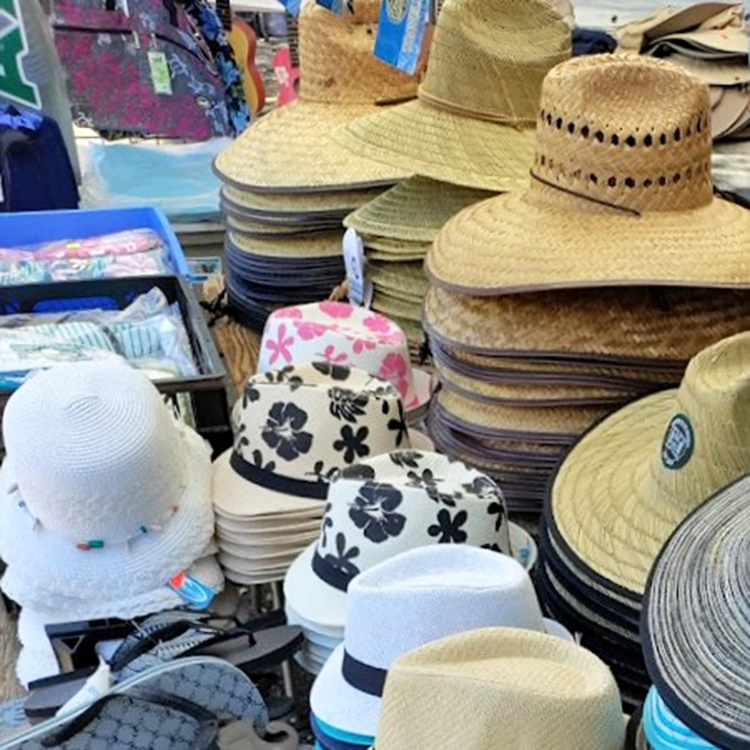 Hat-topia! From beach-ready straws to flower-printed bucket hats, your scalp's salvation from the Hawaiian sun awaits in neatly stacked piles.