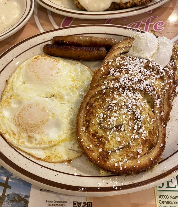 Breakfast perfection on a plate: sunny-side-up eggs alongside French toast dusted with powdered sugar &ndash; the morning equivalent of winning the lottery.