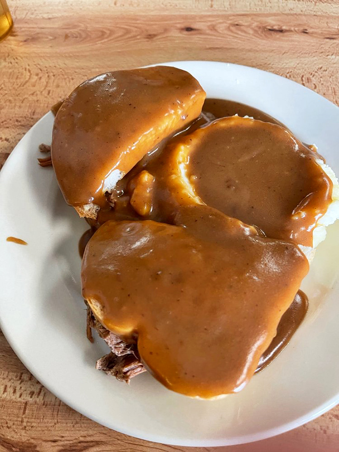 The hot beef sandwich – where bread becomes merely a vessel for gravy delivery. Comfort food engineering at its finest.