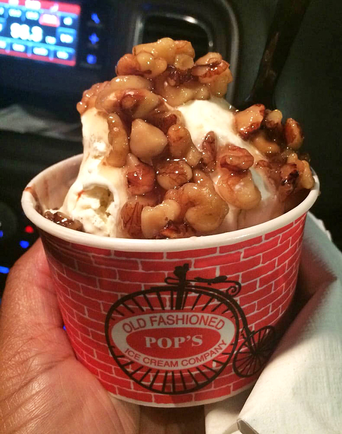 Hot fudge cascading over ice cream with walnuts &ndash; proof that sometimes more really is more.