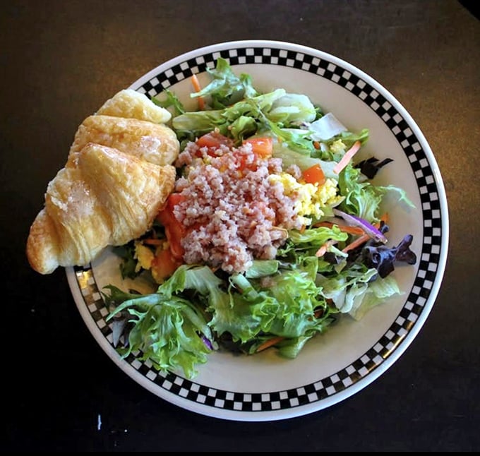 Even the salad gets the star treatment, with fresh greens and a buttery croissant that would make a Parisian nod in approval.