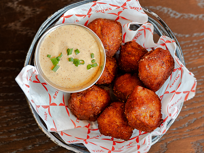 Golden-fried hush puppies with dipping sauce that'll make you want to high-five strangers. Crispy outside, fluffy inside &ndash; the textbook definition of irresistible.