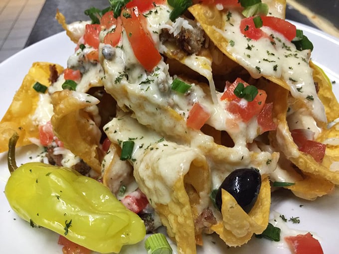 The Italian nachos at Stax Omega rewrite the rules of appetizer physics. Crispy chips supporting an avalanche of cheese, olives, and Italian sausage – Naples meets Nacogdoches in the best possible way.