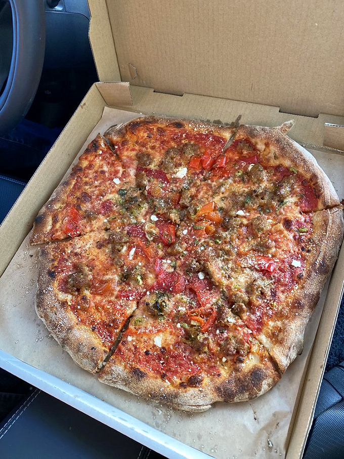 Even in takeout form, this sausage and pepper pizza maintains its dignity – proof that good pizza, like true love, survives the journey home.