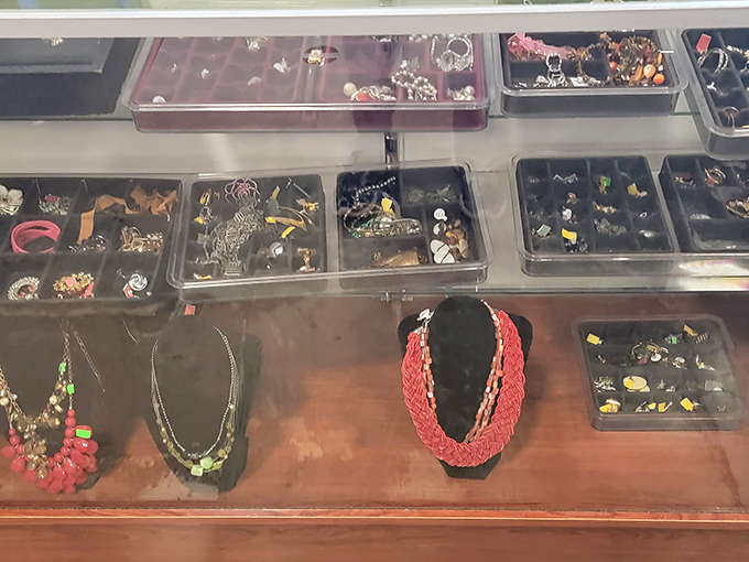 Costume jewelry displayed like archaeological findings. Each piece tells a story—whether it's 1980s prom night or grandma's Sunday best remains part of the mystery.