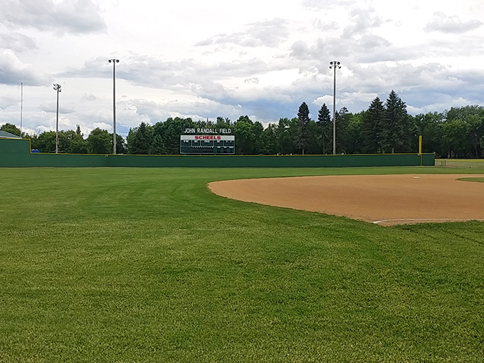 John Randall Field waits quietly for the crack of the bat and cheers from hometown fans who've been keeping score for generations.