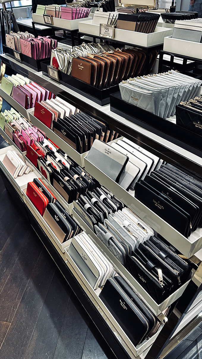 A rainbow of Kate Spade wallets, perfectly arranged like a dessert display for your fashion sweet tooth.