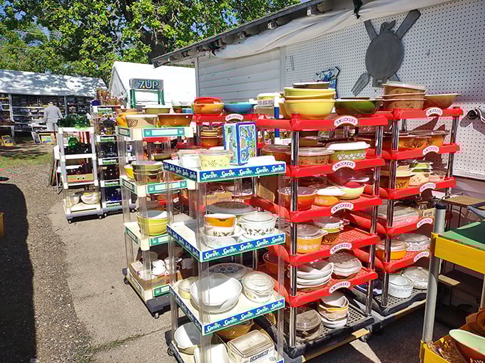 Pyrex bowls in colors your grandmother would recognize stand at attention, waiting to be rescued by collectors who speak fluent vintage kitchenware.