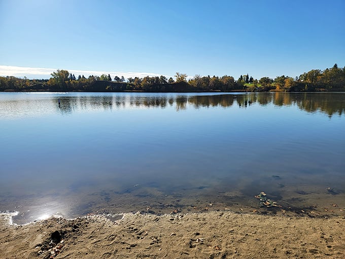 Lake Renwick's mirror-like surface perfectly captures the sky above, creating twice the beauty in a single glance.