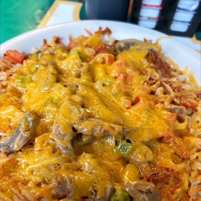 Cheese blankets, vegetable treasures, and perfectly crisped potatoes&mdash;this isn't just loaded hash browns, it's comfort food architecture at its finest.