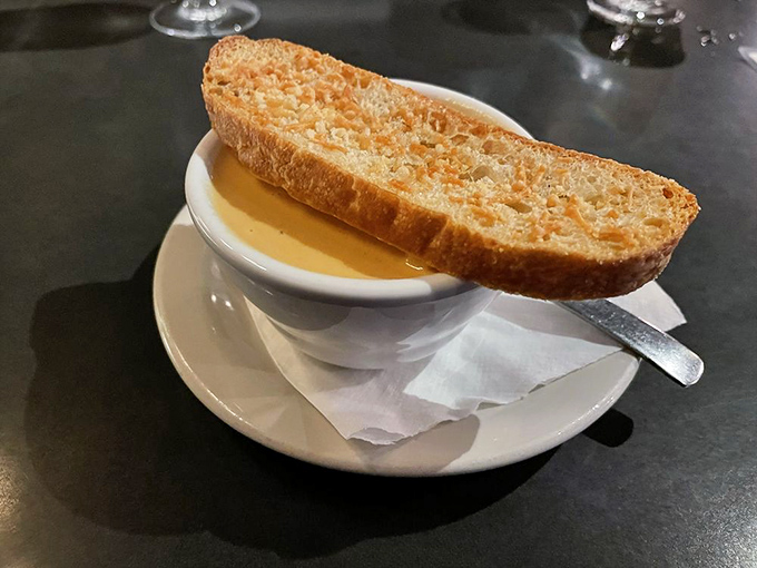 A slice of perfectly toasted bread perched atop a bowl of lobster bisque &ndash; the ultimate wingman for this velvety, soul-warming soup.