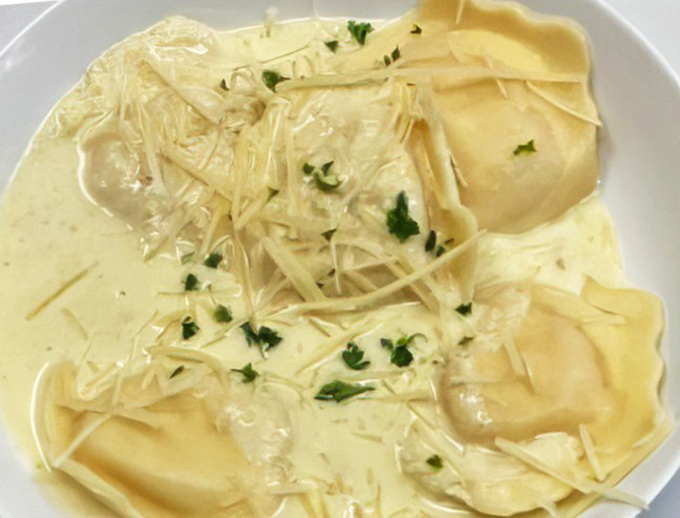 Lobster ravioli swimming in a creamy sea of heaven &ndash; pasta pillows filled with treasures from the deep. Comfort food gets fancy.