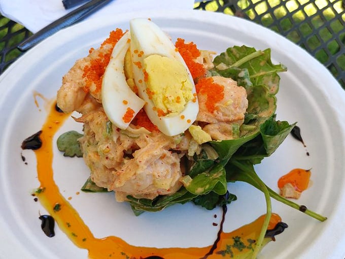 This isn't just lobster salad&mdash;it's a masterclass in balance. The creamy seafood mixture, perfectly cooked egg, and vibrant greens create a symphony that Mozart would have envied.