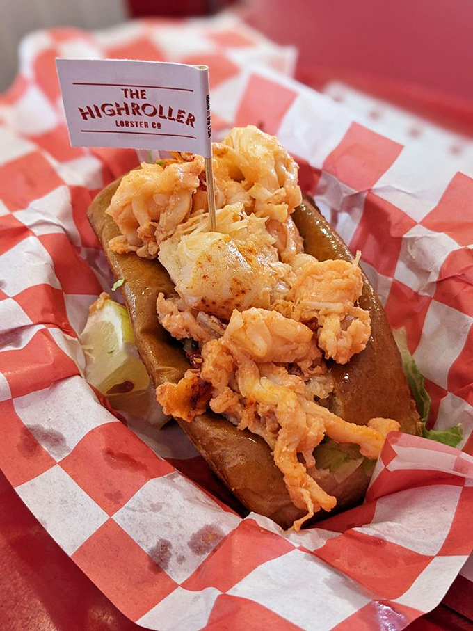 The classic lobster roll in all its glory&mdash;buttery bun, generous meat, and a tiny flag claiming this delicious territory in the name of Highroller.