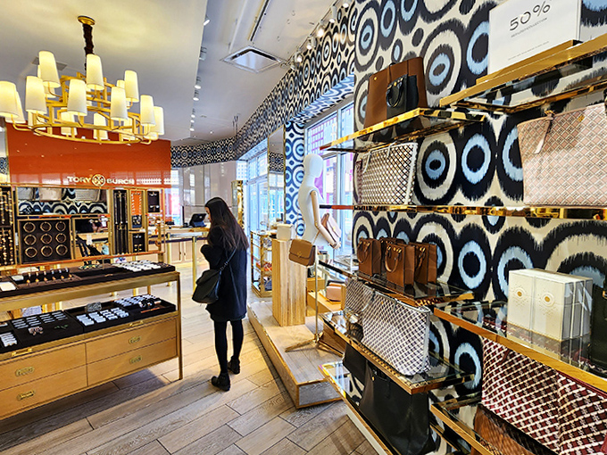 Tory Burch's signature style shines in this boutique where geometric patterns and golden accents frame discounted treasures waiting to be discovered.