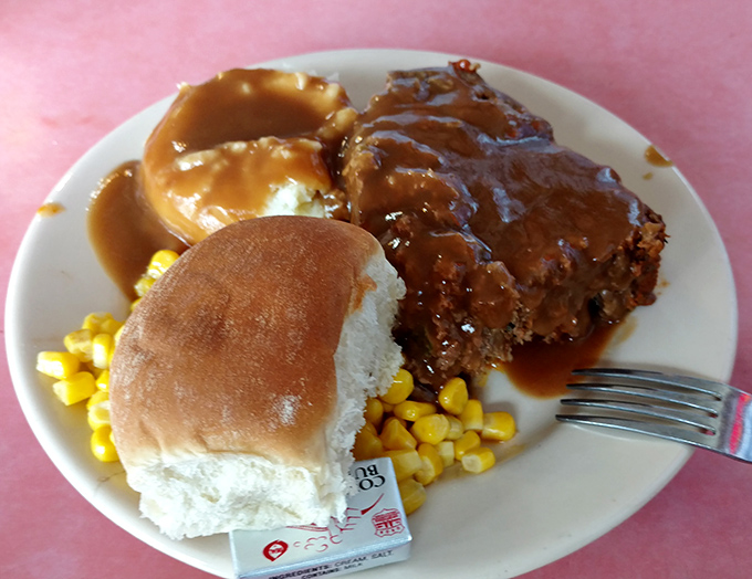 Meatloaf that would make your grandmother nod approvingly, swimming in gravy that deserves its own zip code.