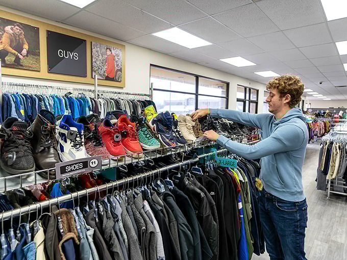 A shopper contemplates his next fashion move in the men's section. That moment when you realize designer labels don't require designer prices.