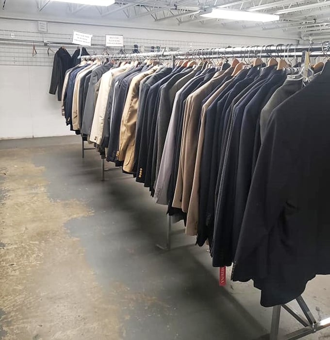 The men's suit section: where second interviews, weddings, and funeral attire await their next assignment. That camel blazer might just be your new power move.