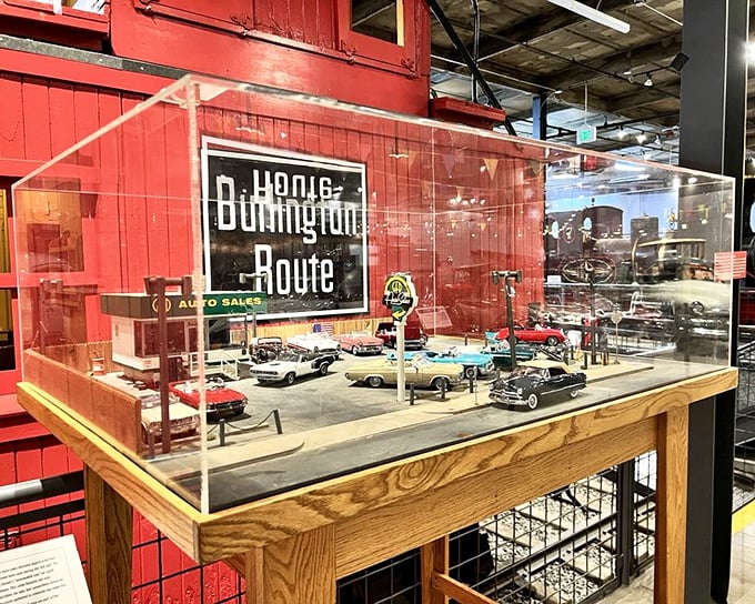 This meticulously crafted miniature auto dealership diorama captures the golden age of American car culture, when showrooms were shrines to chrome and possibility.
