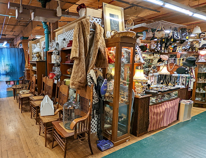 Where vintage fur coats and antique display cases create neighborhoods of nostalgia within the market's sprawling landscape.