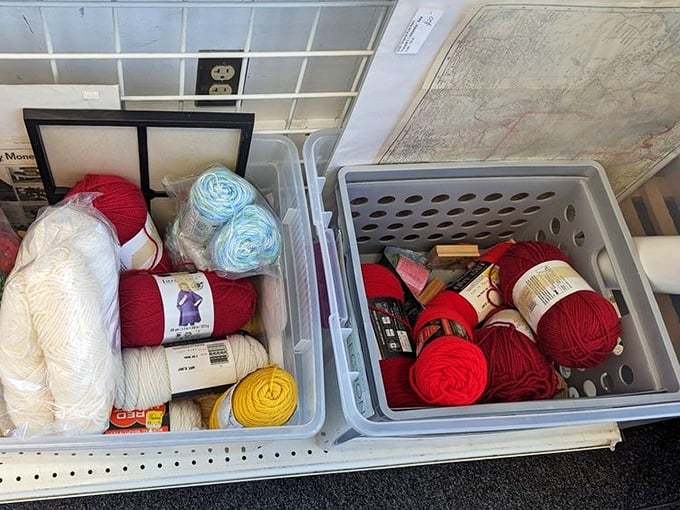 A crafter's dream come true! Balls of yarn in every shade of red and white &ndash; someone abandoned their project, but your creativity awaits.
