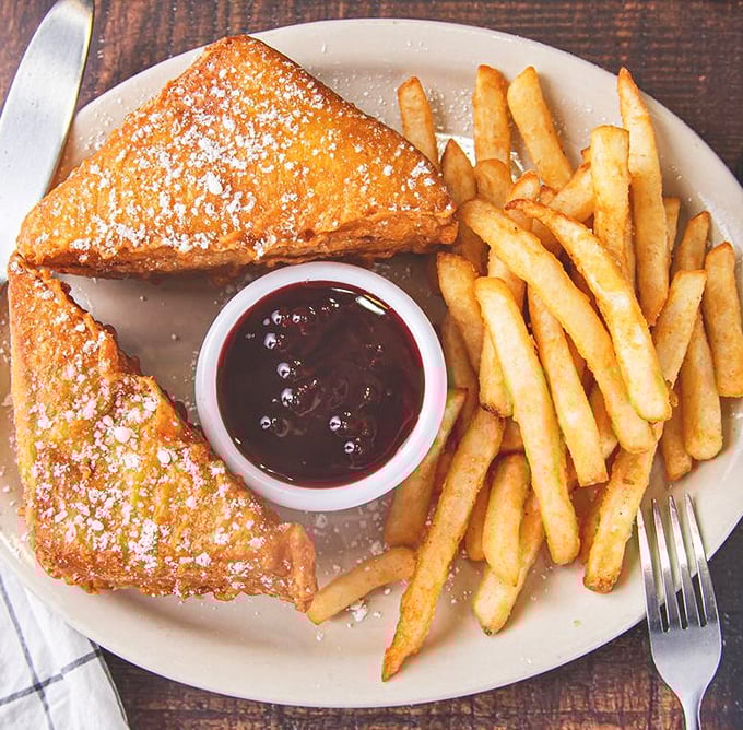 The Monte Cristo sandwich dusted with powdered sugar transforms lunch into a sweet and savory celebration.
