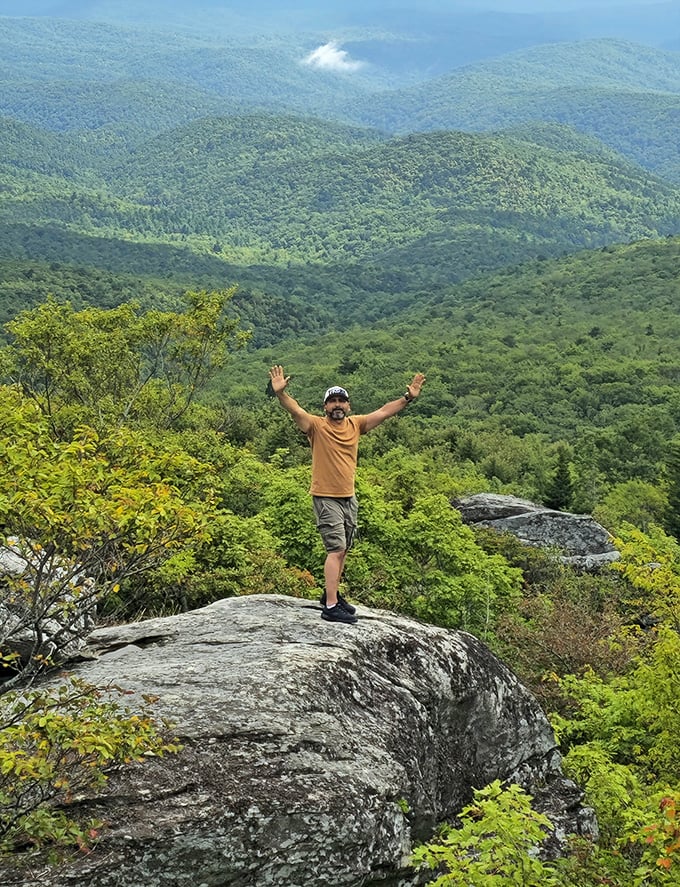 Arms out is the universal pose for "I found something amazing!" The mountains below seem to stretch into tomorrow.