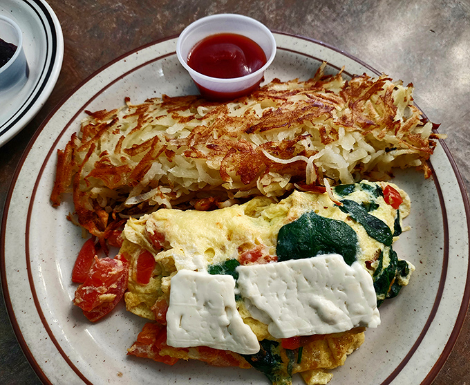 This Greek omelette with crispy hash browns is the breakfast equivalent of hitting the jackpot before your first cup of coffee.