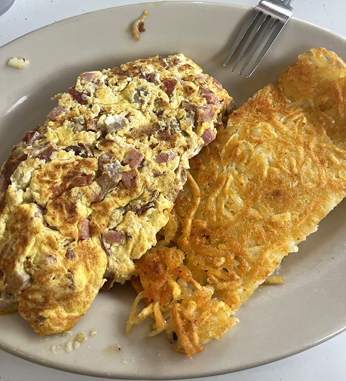 The classic diner duo&mdash;a ham-studded omelet alongside hash browns with that magical crispy exterior that makes you wonder why you ever bother cooking at home.