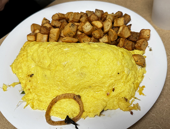 This fluffy omelet with home fries isn't just breakfast&mdash;it's morning salvation for anyone who woke up wondering if happiness still exists.
