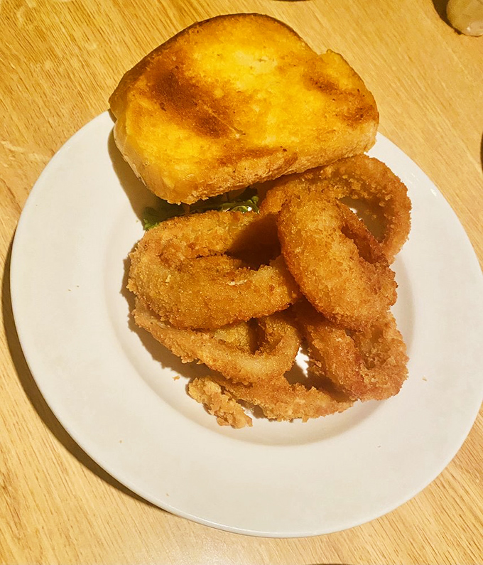These golden onion rings and cheese toast aren't just sides – they're supporting actors who deserve their own spin-off show.