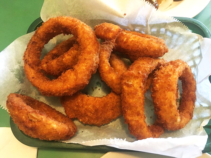 These onion rings aren't just fried&mdash;they're golden halos of happiness that crunch loud enough to turn heads three booths away.