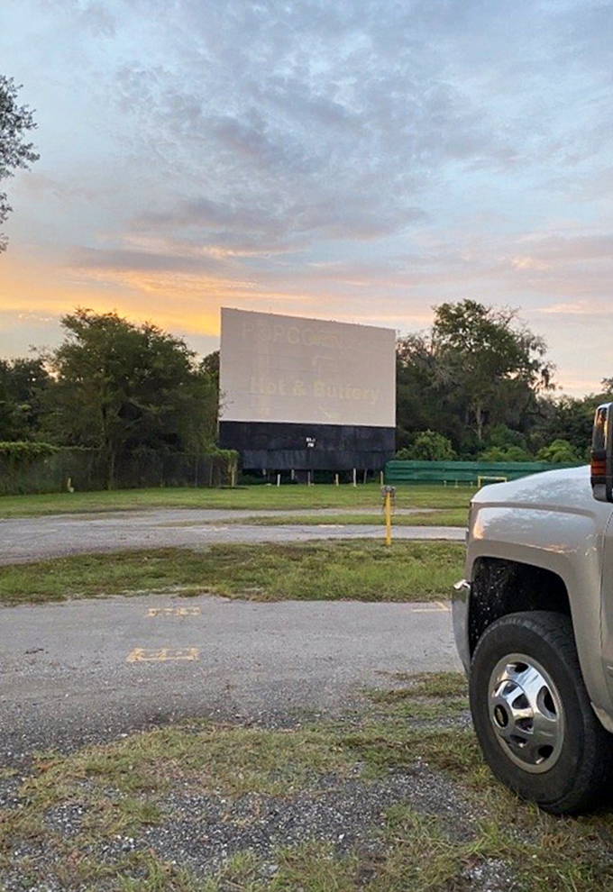 Sunset casts a golden glow on the Joy-Lan's screen, while a concert setup hints at the venue's versatility beyond just movies.