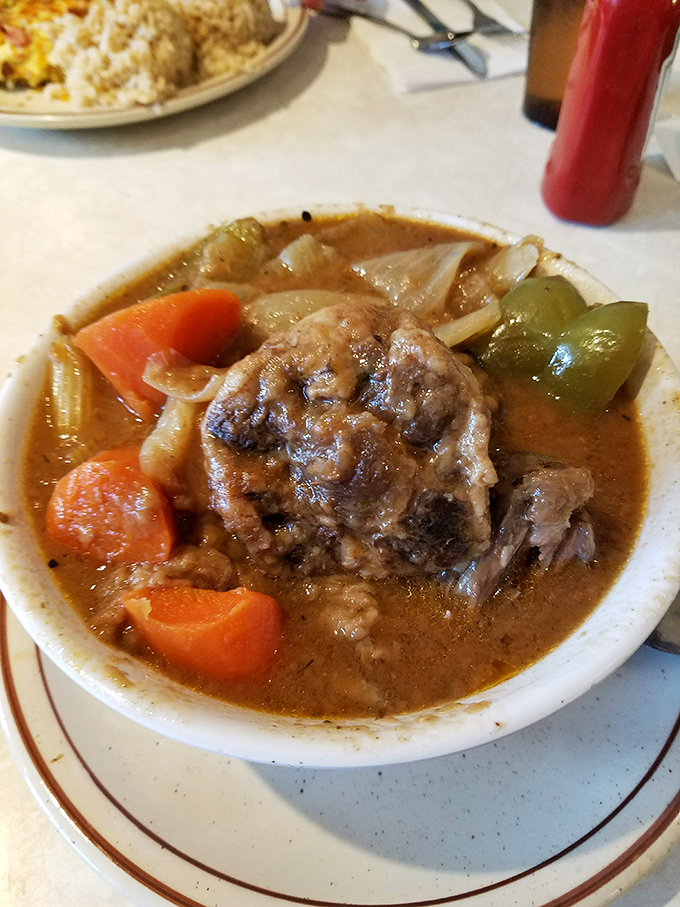 Oxtail stew that simmers with such patience, the meat practically surrenders to your spoon before you even touch it.