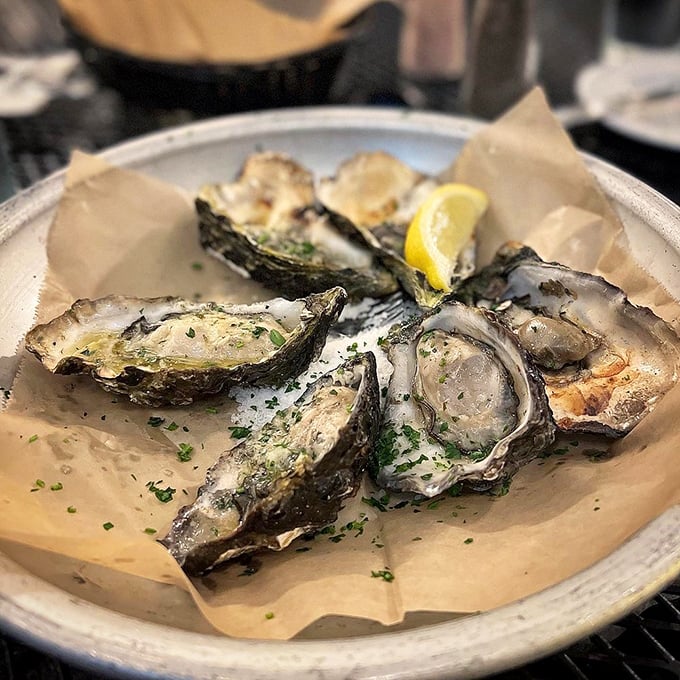 These oysters aren't just served; they're presented with reverence. Nestled on ice with a wedge of lemon, they're ocean freshness distilled into perfect briny bites.