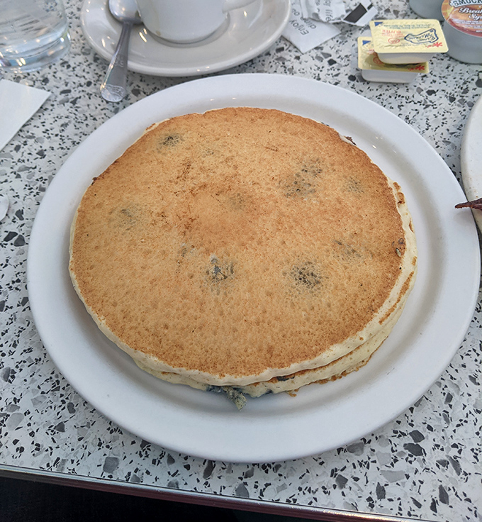 This pancake isn't just large&mdash;it's approaching frisbee dimensions. Golden-brown, slightly crisp at the edges, and ready to soak up rivers of maple syrup.