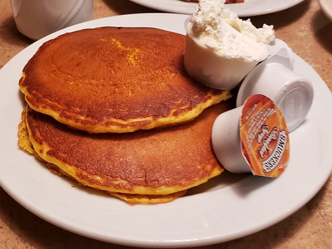 These golden-brown pancakes aren't just breakfast, they're therapy&mdash;three perfect circles of comfort served with butter melting into every delicious pore.