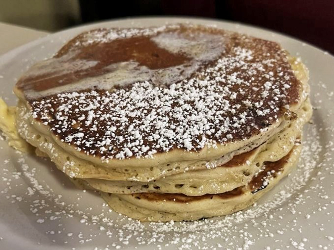 Pancakes dusted with powdered sugar like the first perfect snowfall of winter—simple, beautiful, and gone too quickly.