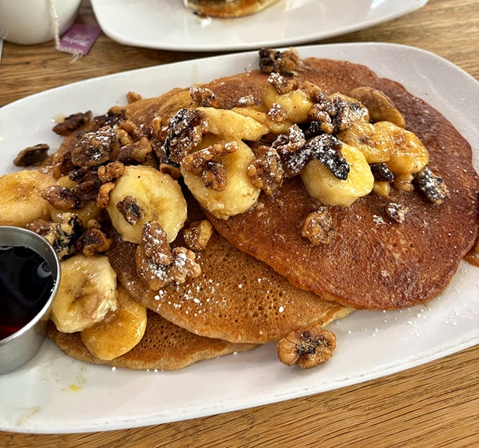 These pancakes aren't just breakfast, they're an event &ndash; topped with bananas, nuts, and enough maple syrup to make a Canadian blush.