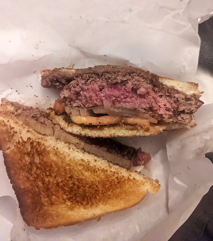 Cross-section reveals the truth&mdash;a perfectly pink medium-rare center with caramelized edges. This burger has nothing to hide and everything to show off.