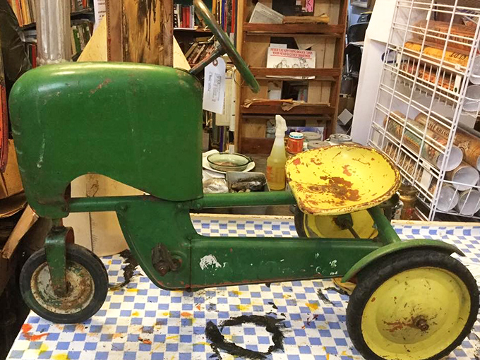 Before PlayStation, this green machine was childhood royalty. The worn paint and yellowed wheels tell tales of driveways conquered and imaginary farms tended.