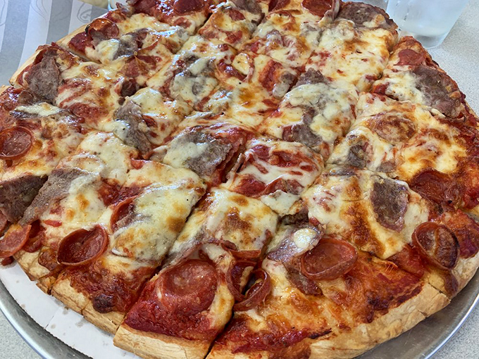 The pepperoni and sausage pizza achieves that perfect ratio of meat to cheese to sauce, like a harmonious trio playing your favorite comfort food melody.