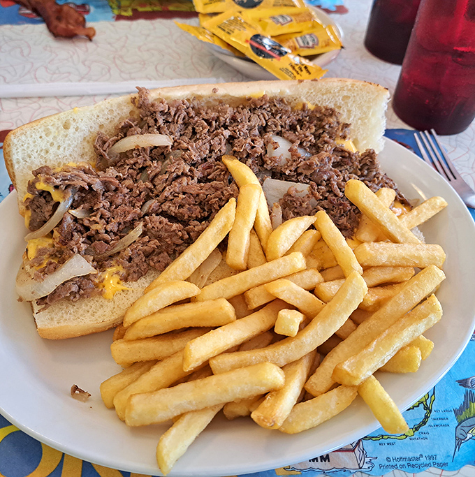 The Philly Cheesesteak is piled so high with meat and cheese, it defies the laws of sandwich physics entirely.