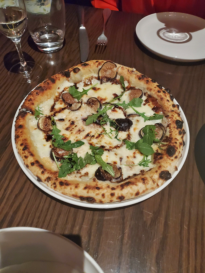 The Funghi pizza: where mushrooms and a perfectly charred crust come together in wood-fired harmony that'll haunt your dreams.